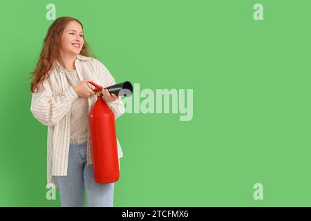 Young woman with fire extinguisher on pink background Stock Photo - Alamy