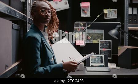 African american detective reviewing clues to solve crime case. Police ...