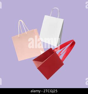 Colorful shopping bags falling on light blue background Stock Photo - Alamy