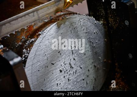 Cutting metal casting with band saw machine at plant Stock Photo - Alamy