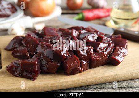Cut raw beef liver on wooden table, top view Stock Photo - Alamy