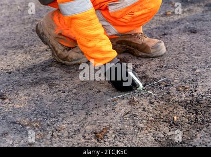 Surveyor operating his touch screen controller instrument during ...