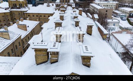Drone photography of old prison rooftop with chimneys during winter day ...