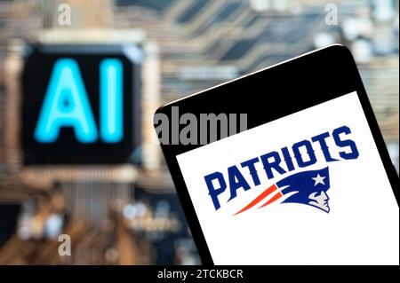 The New England Patriots logo is seen on a helmet along the sidelines ...
