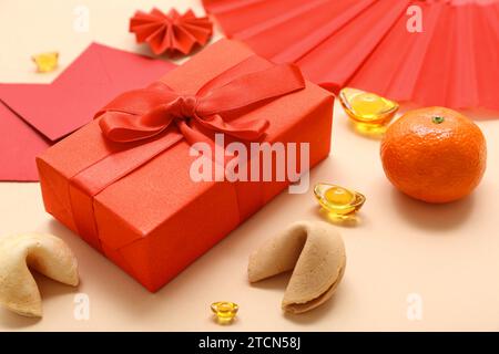Gift box with fortune cookie, mandarin and Chinese symbols on red ...