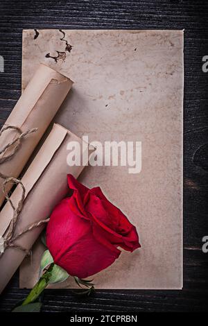 Vintage corded paper rolls red natural rose on wooden board Stock Photo ...