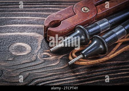 Electric tester on vintage wooden board top view Stock Photo - Alamy