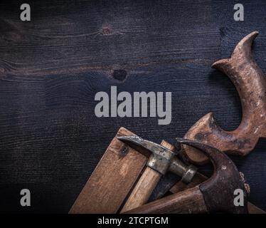 Composition of vintage square ruler rusted claw hammers hand saw Stock ...