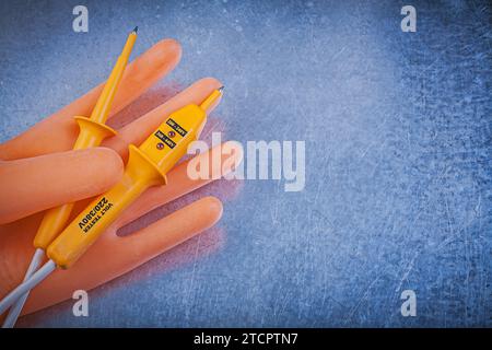 Dielectric rubber gloves Electrical test device on metallic background ...
