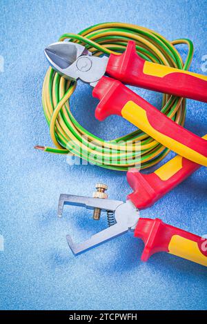 Metal pliers with electric cable on white background. Technology ...