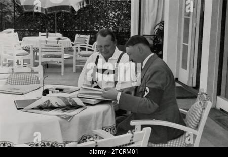 German Chancellor Adolf Hitler taking the salute at the great parade of ...