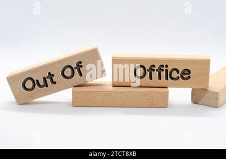 Out of office text on wooden blocks with laptop background. Out of ...