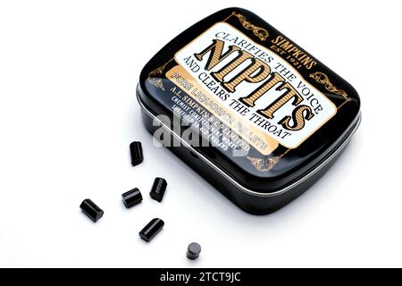 Tin of Simpkins Nipits Pure Liquorice Pellets Spilling onto a White ...