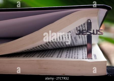 Bible and christian cross with the name of Jesus. Symbol of ...