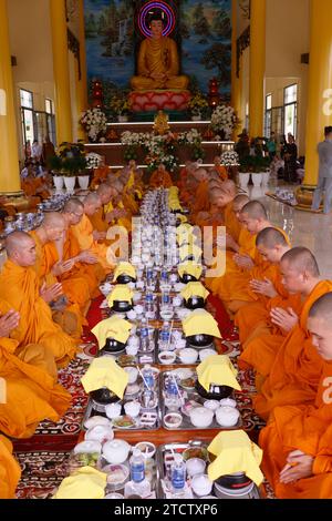 Vegetarian meal, monks at Buddhist ceremony in the main hall, Phuoc Hue ...