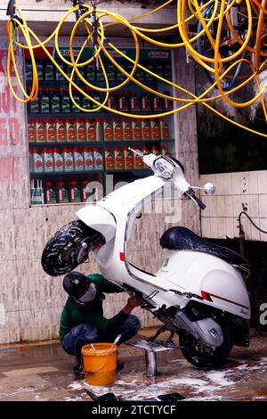 Employee washing a scooter Stock Photo - Alamy
