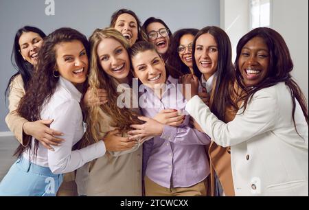 Happy cheerfull young diverse women friends or coworkers looking at ...