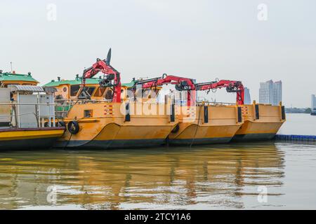 Small several row of ships with a claw manipulator hand parked at the ...