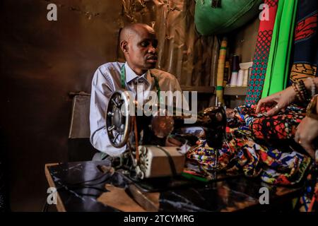 Richard Onyango (R) a tailor at Afrowema and Tatiana Teixeira checks on ...