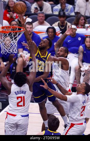 Golden State Warriors' Andrew Wiggins, left, shoots against Denver ...