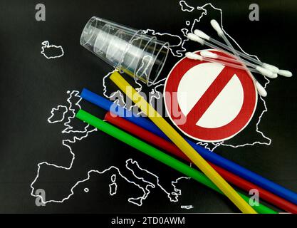Plastic straws, cups and cotton buds on a map of Europe with a stop ...
