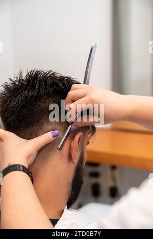 Cropped hands of man shaving customer at barber shop Stock Photo - Alamy
