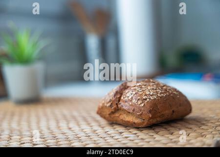 A seed-encrusted artisan bread loaf on a pine wood cutting board, with ...