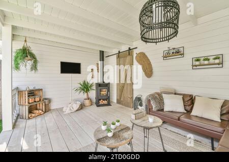 Comfortable white sofa and wooden coffee table with books on yellow ...