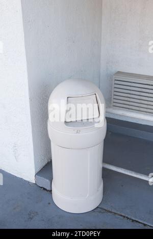 Dustbin against wall Stock Photo - Alamy