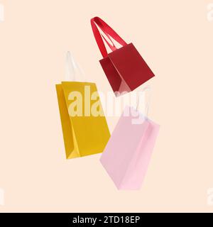 Colorful shopping bags falling on beige background Stock Photo - Alamy