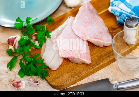 Raw rockfish fillet with condiments, food preparation Stock Photo - Alamy