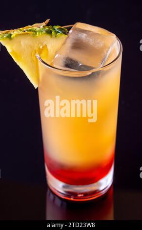 Reggae Rum Punch Cocktail garnished with pineapple wedge Stock Photo ...
