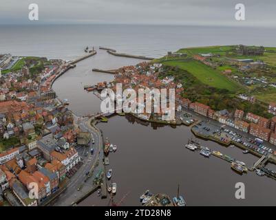 Whitby, North Yorkshire. Aerial View of the town and harbour featuring ...
