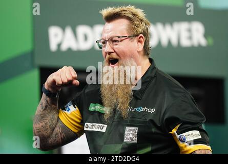 Simon Whitlock reacts after beating Paolo Nebrida (not pictured) on day ...