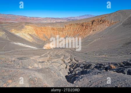 Colorful deposits of volcanic ash in reds and yellows against a green ...
