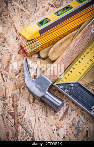 construction protective glove and claw hammer on wooden board Stock ...