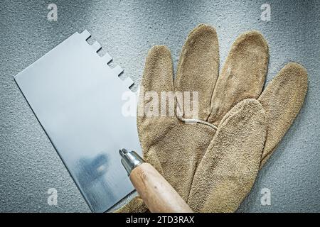 Bricklaying trowel working gloves on concrete background construction ...