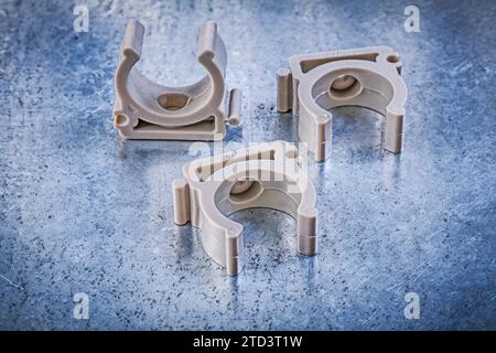 Collection of water pipe clamps on metallic background construction ...