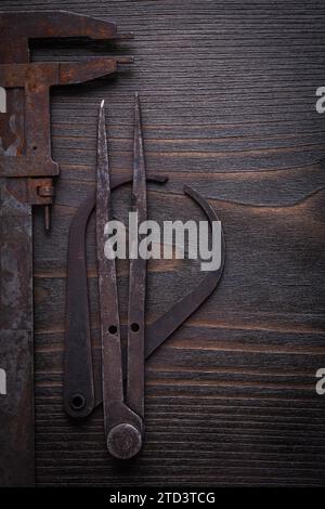 Collection of rusty vernier scales on vintage wooden board Stock Photo ...