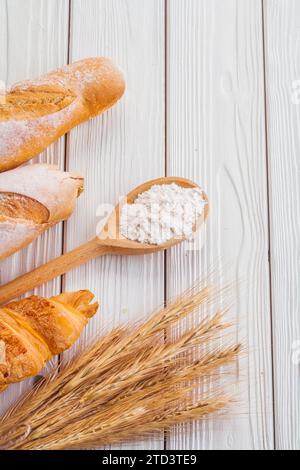 baguettes and croissant wheat ears on wooden boards with copyspace ...