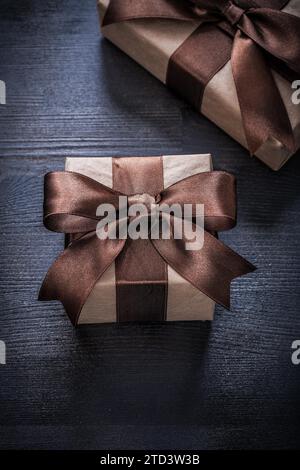 Present boxes with tied ribbons on golden surface holidays concept ...