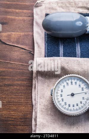 blood pressure monitor on vintage wooden board close up medical comcept ...