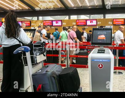People stand in front of an electronic stock board showing Japan's ...