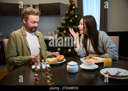 Upset man with screaming wife during celebration of Christmas Stock ...