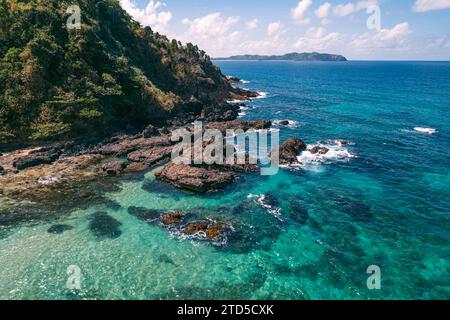 waves of the ocean break on the stone coast against the backdrop of the ...
