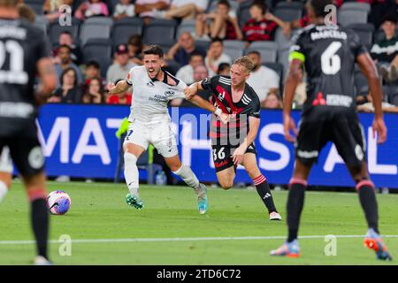 Oscar Priestman of the Wanderers competes for the ball with Ethan ...