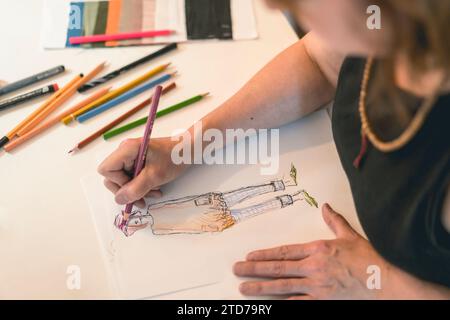 Fashion designer drawing a fashion sketch with colorful pencils Stock ...