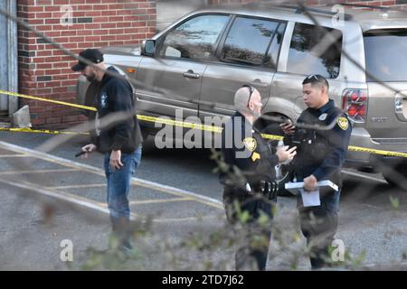 Police officers search for clues and mark evidence located at the crime ...