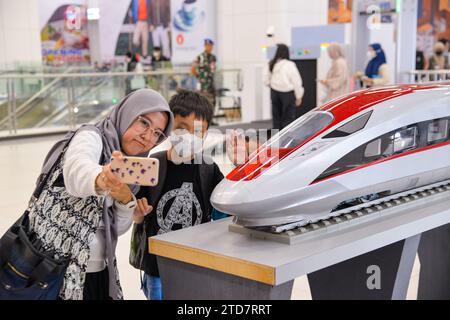 Jakarta, Indonesia. 17th Dec, 2023. Two boys look at a model of a high-speed electrical multiple ...
