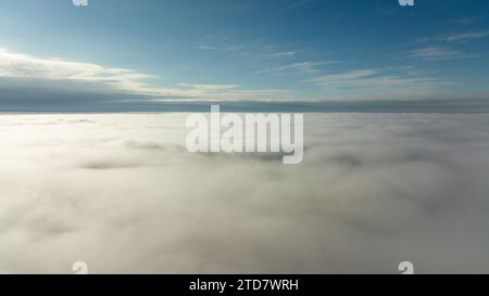 CFlying high above the clouds. Aerial view of clouds and horizon from ...